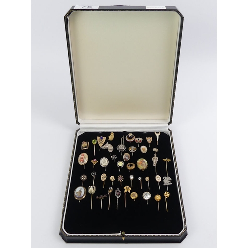 A collection of assorted stick pins, including a bug example and ...