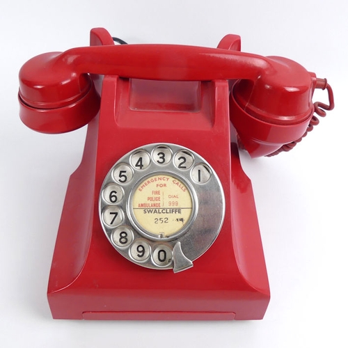 A vintage red bakelite telephone, the handset marked GPO PL35 234 No ...