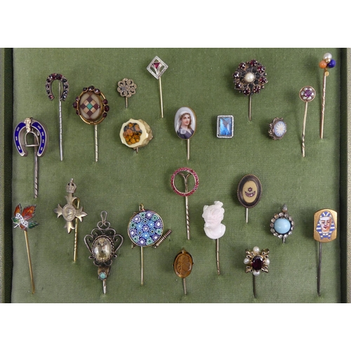 A collection of Victorian and later stick pins, including a carved ...