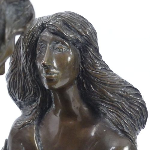A 20th century bronze figure of a seated couple on a naturalistic base ...