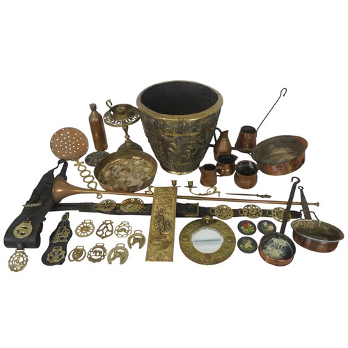 A collection of metalware, including copper saucepans, moulds, horse ...