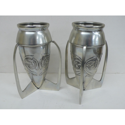 A pair of Archibald Knox style pewter rocket shaped vases height 18.5cms