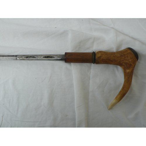 A sword stick with antler handle, double edged blade with pierced ...