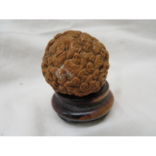 Chinese carved walnut with the faces of figures in a crowd, diameter ...