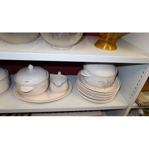 A fawn floral patterned dinner service