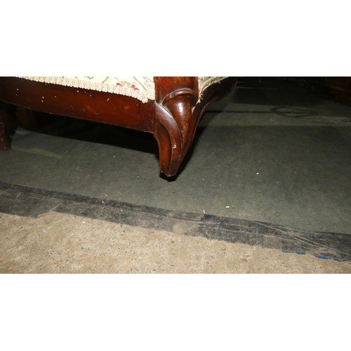 A Victorian mahogany two seater settee with floral patterned buttoned ...