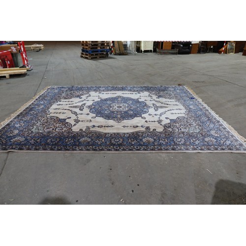 A blue and fawn floral patterned carpet approximately 2m 98 cm by 3m 90 cm