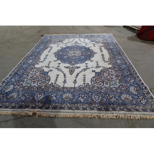 A blue and fawn floral patterned carpet approximately 2m 98 cm by 3m 90 cm