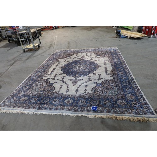 A blue and fawn floral patterned carpet approximately 2m 98 cm by 3m 90 cm