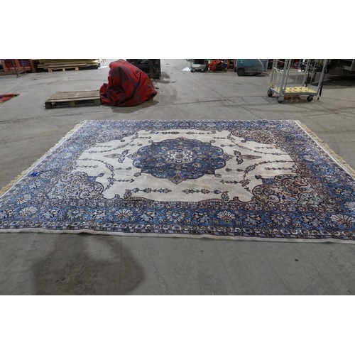 A blue and fawn floral patterned carpet approximately 2m 98 cm by 3m 90 cm