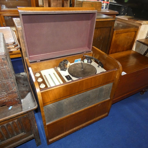 A vintage Ferguson wooden cased radiogram with a lift lid enclosing a ...