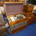 A vintage Ferguson wooden cased radiogram with a lift lid enclosing a ...