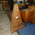 A triangular hardwood chest of 5 graduated drawers