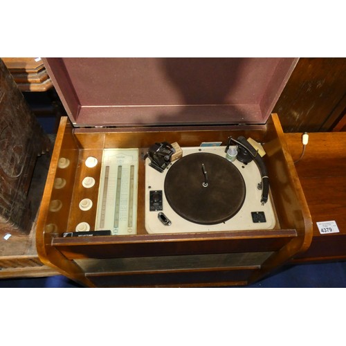 A vintage Ferguson wooden cased radiogram with a lift lid enclosing a ...