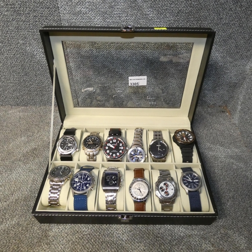 A gentleman's watch box containing 12 costume wristwatches by; Swatch ...