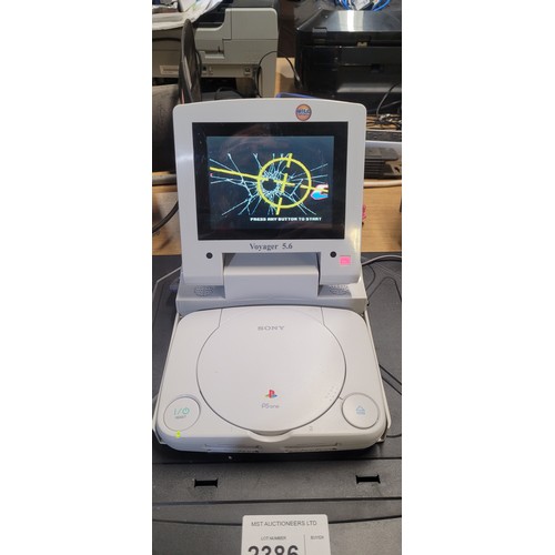 A Sony Playstation 1 console with voyager 5.6 in car portable screen a quantity of top rated games