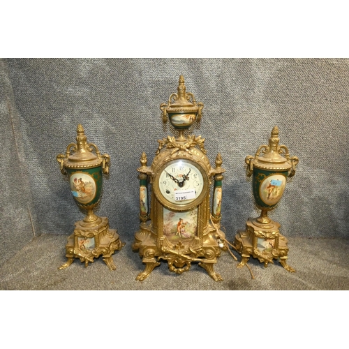 A very ornate gilt work clock set with painted ceramic panels and ...