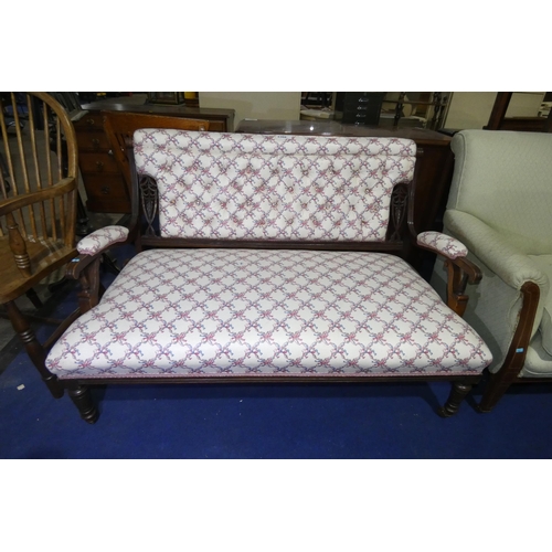 An Edwardian mahogany two-seater settee with decorative buttoned ribbon ...
