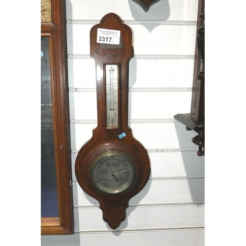 An Edwardian inlaid mahogany banjo-shaped aneroid barometer