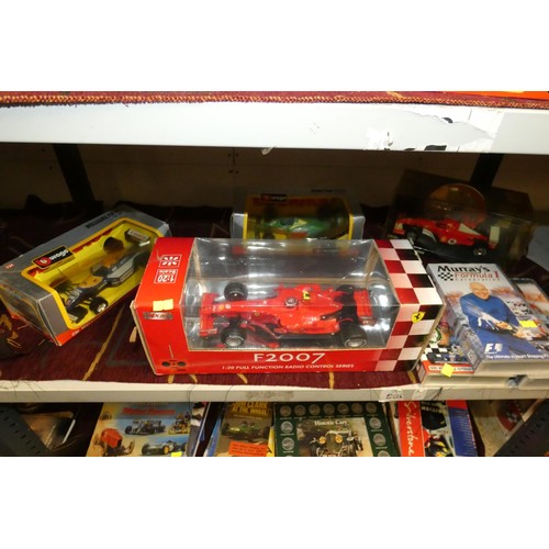 A collection of boxed model racing cars and a quantity of motor racing ...