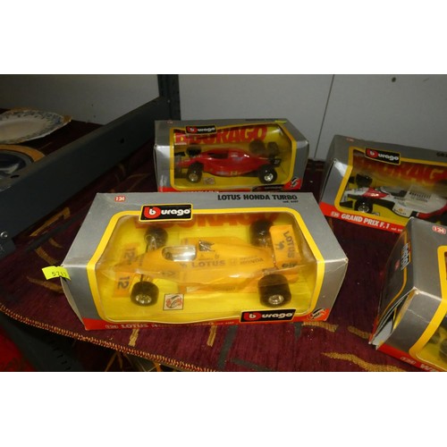 A collection of boxed model racing cars and a quantity of motor racing ...