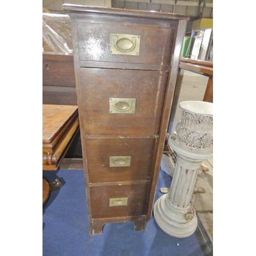 A vintage wooden four drawer filing cabinet with inset brass handles ...