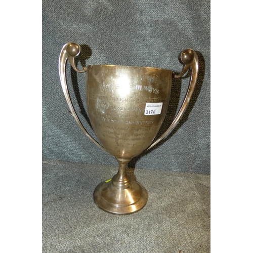 A large heavy silver two handled trophy cup on a circular foot, weight ...
