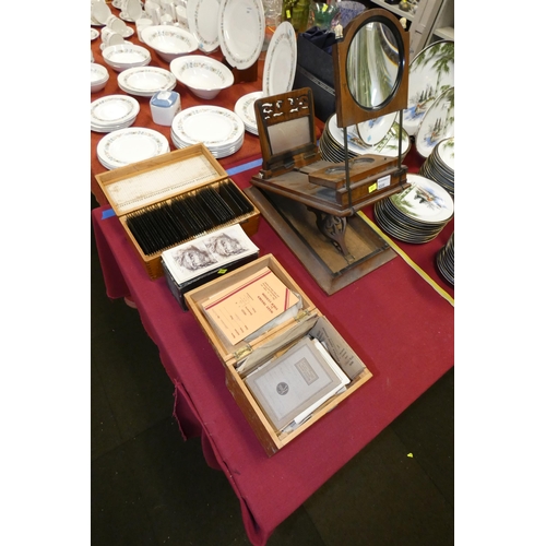 A Victorian walnut graphoscope with a collection of stereo cards, glass ...