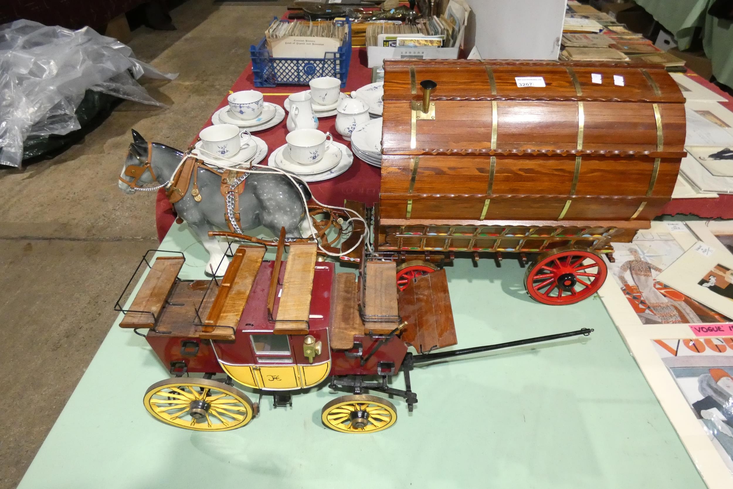 A large model gypsy caravan with a ceramic horse and a wooden model of ...