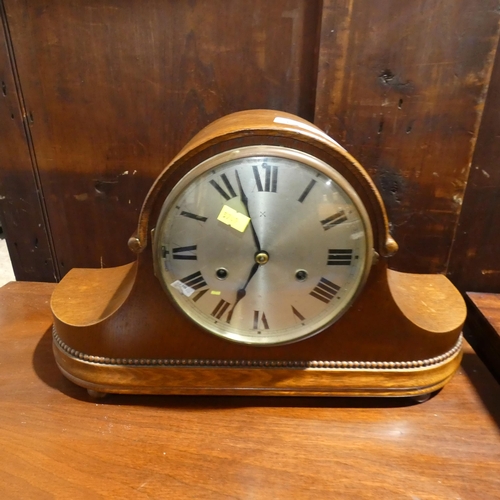 An oak cased domed top mantle clock