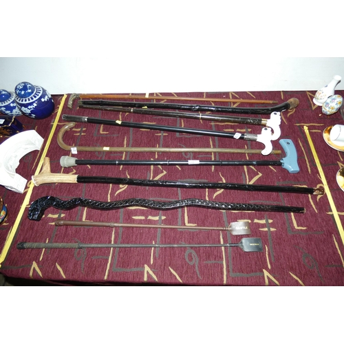 A collection of miscellaneous decorative walking sticks and riding crops