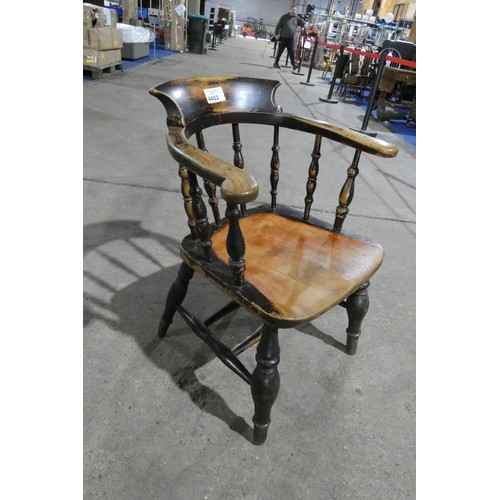 An Edwardian Elm smokers bow chair with a spindle back