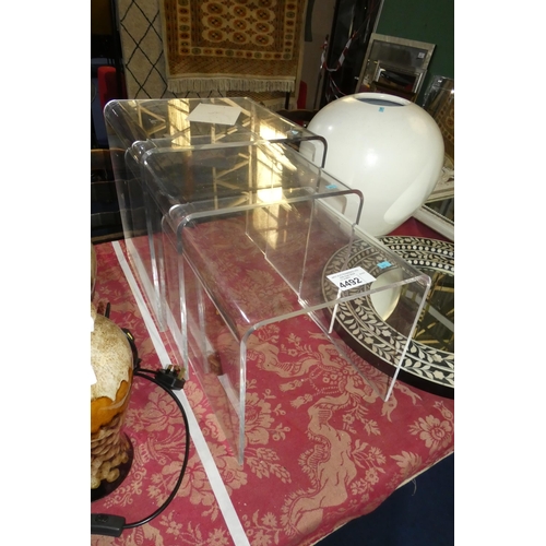 A list of three perspex coffee tables