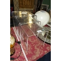 A list of three perspex coffee tables