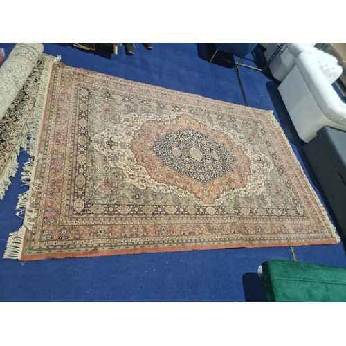 Three decorative patterned rugs and a small red rug 1 measuring approx ...