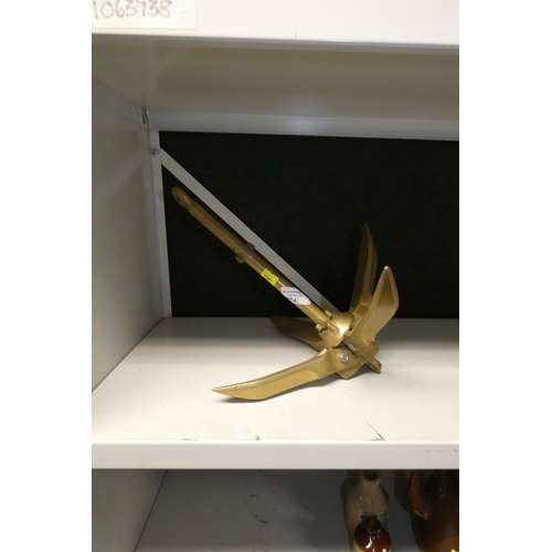 A brass retractable marine anchor