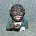 A reproduction cast iron Jolly Boy money box / coin bank