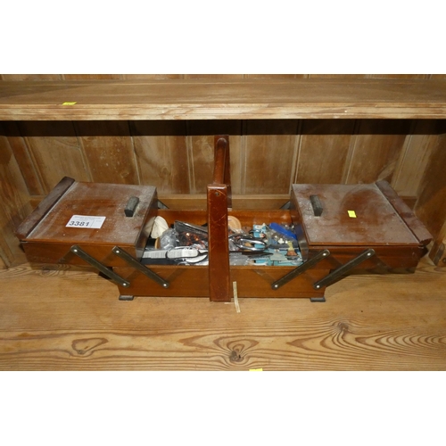 A vintage concertina folding sewing box with sewing paraphernalia