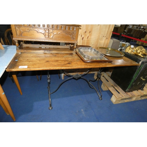 A rectangular topped oak dining table with metal trestle supports ...