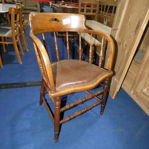 An Edwardian Oak smokers bow chair with a spindle back