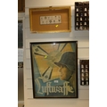 A framed Nazi war poster and a small framed collage of Nazi badges