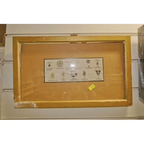 A framed Nazi war poster and a small framed collage of Nazi badges
