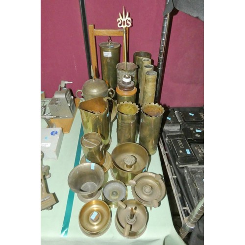 A quantity of brass shell cases, vintage trench art ornaments, a shell ...