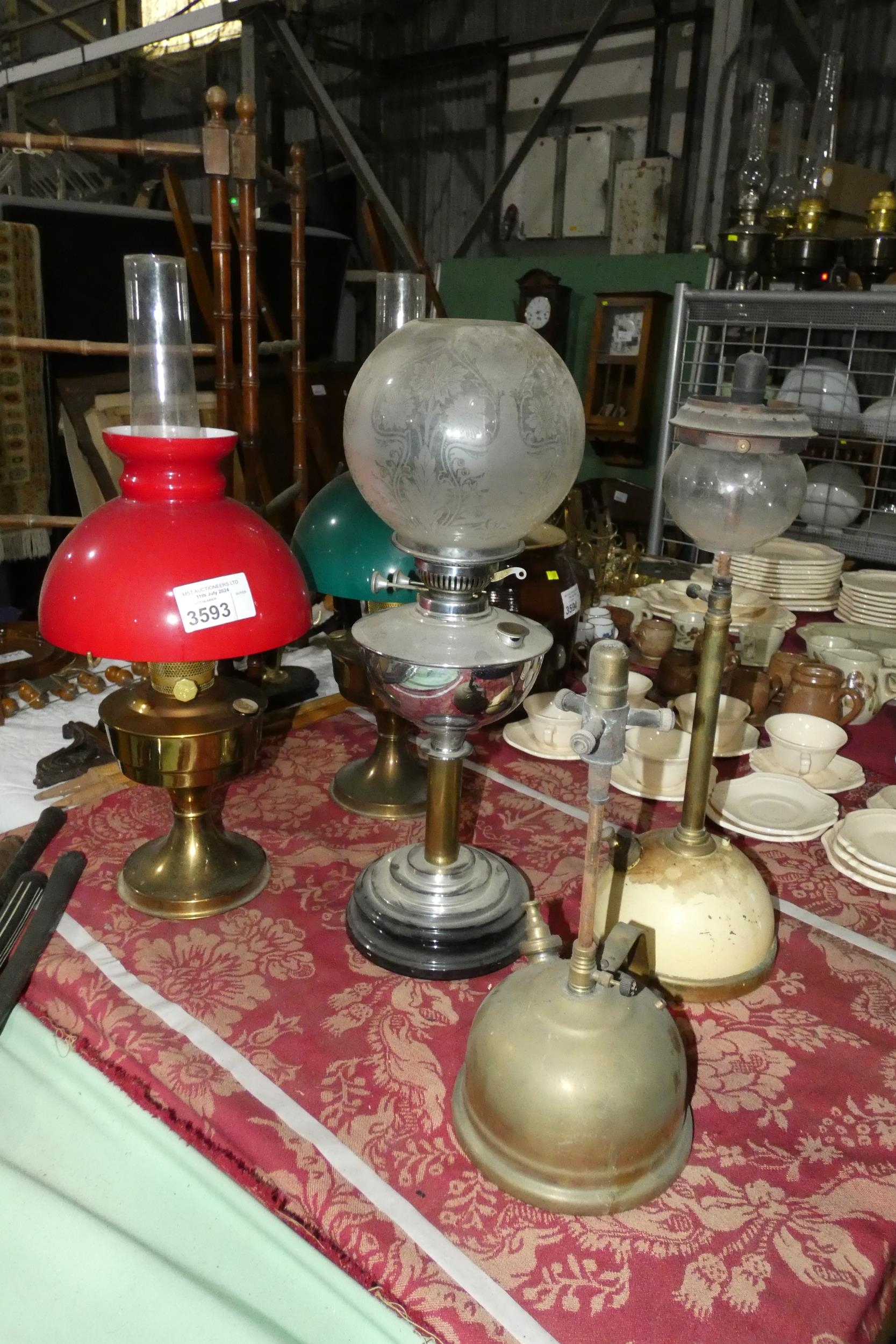 Three vintage oil lamps with coloured glass shades and two vintage ...