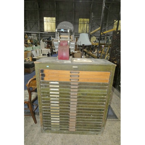 A vintage Adana printing press and a wooden multi drawer printing cabinet