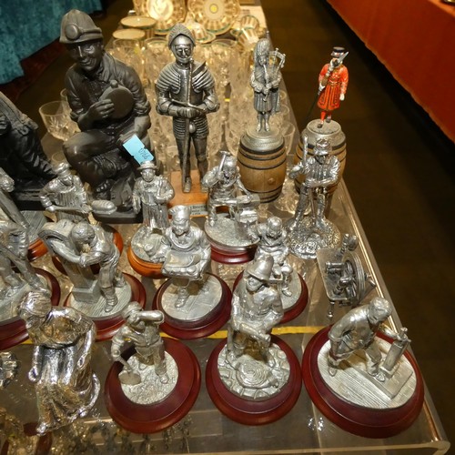 A collection of miniature white metal figurines of tradesmen and other ...