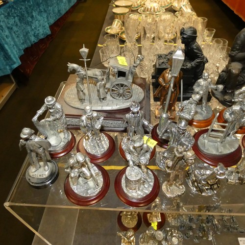 A collection of miniature white metal figurines of tradesmen and other ...