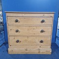 A vintage pine chest of three graduated drawers with turned knobs ...