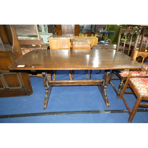 A vintage Ercol dark wood rectangular topped refrectory style dining table