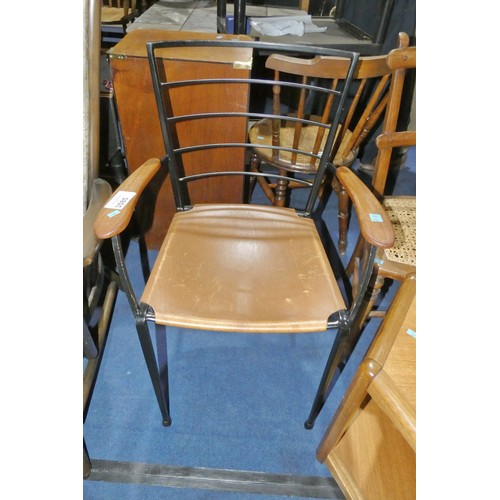 A vintage black metal ladder-back elbow chair with a leather seat